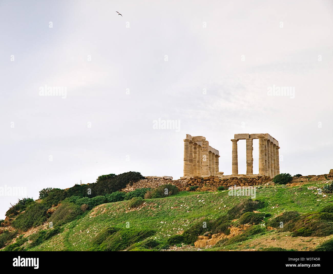 Ancient ruins of Poseidon temple under sky with clouds at winter time ...