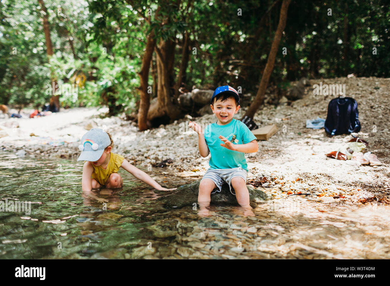 Boy girl sitting on rock hi-res stock photography and images - Alamy