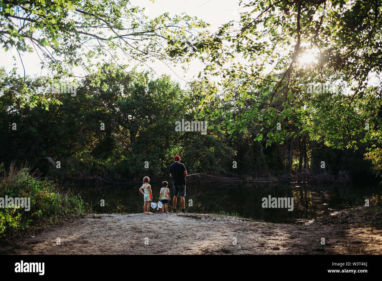 Young girl and boy helping dad fish at lake in summer Stock Photo - Alamy