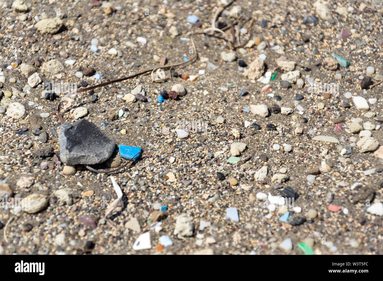 Microplastics pollution washed up on sandy beach, view from above Stock ...