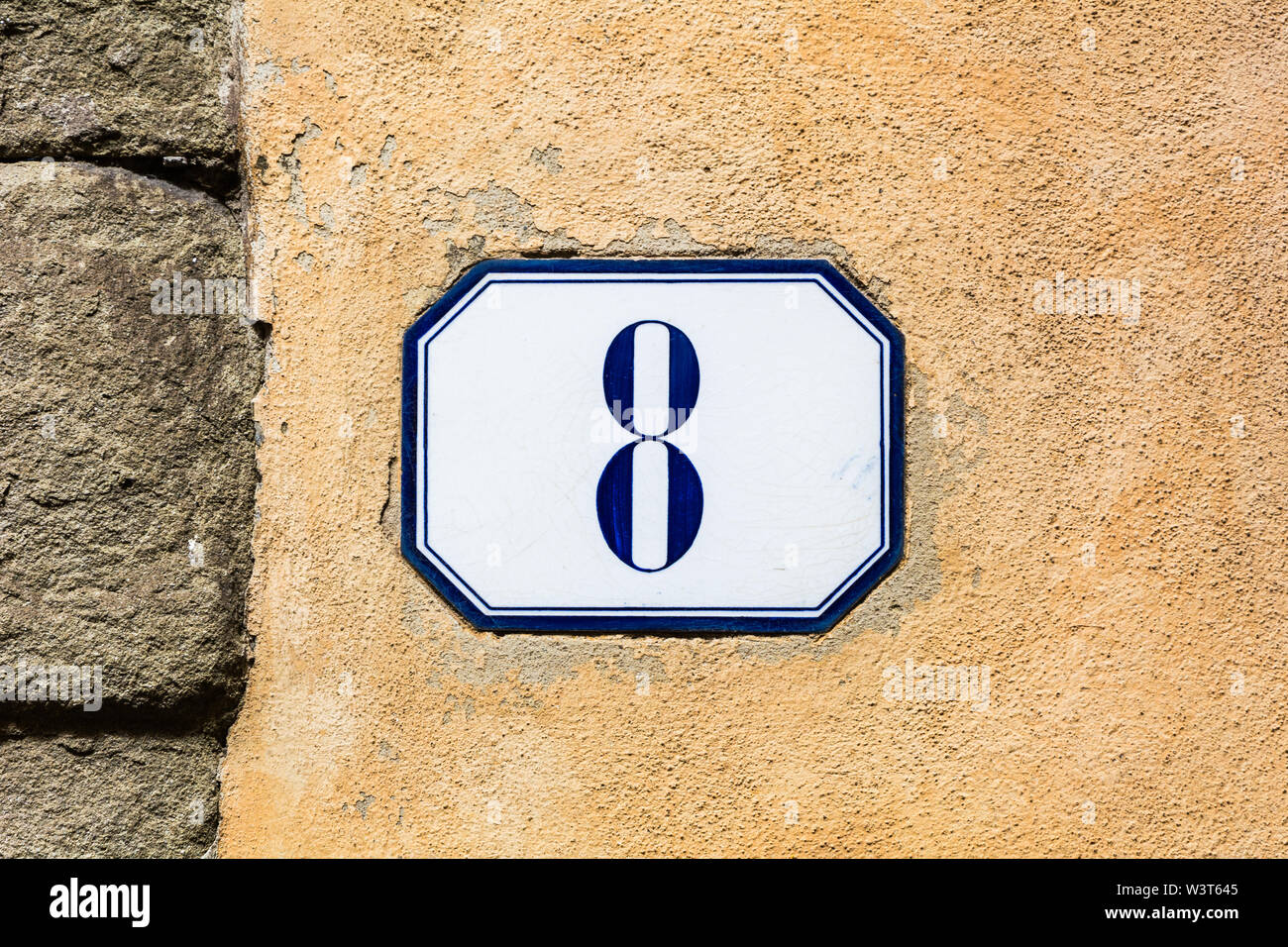 house number eight , eighth ( 8 ) on a roughcast wall Stock Photo - Alamy