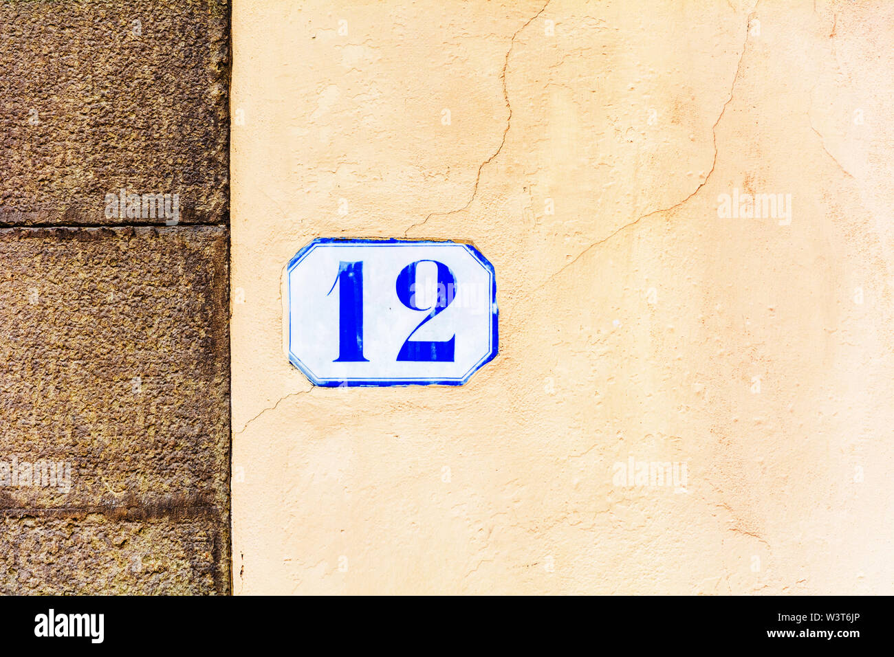 house number twelve ( 12 ) on a roughcast wall Stock Photo - Alamy