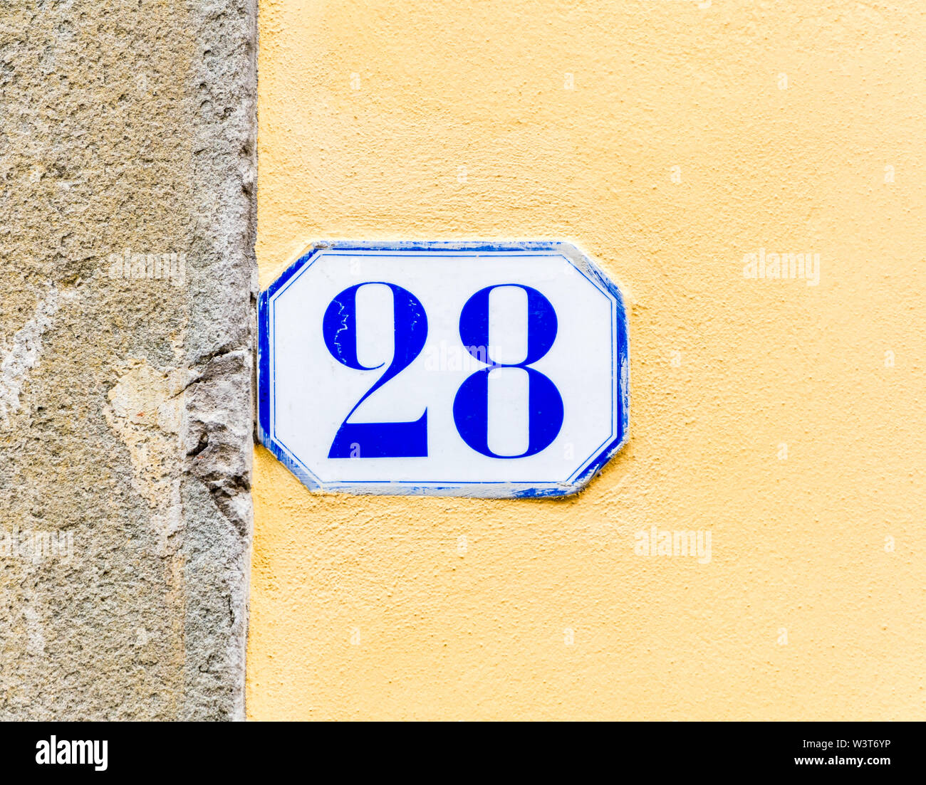 house number twenty eight ( 28 ) on a roughcast wall Stock Photo - Alamy