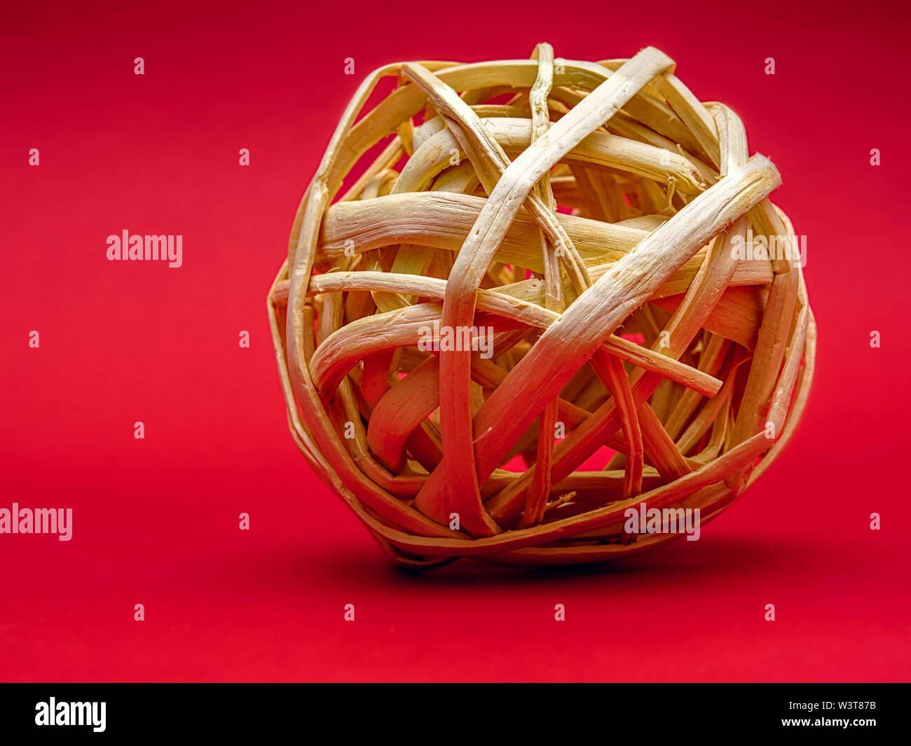 Decorative rattan ball isolated on red background with copy space Stock ...