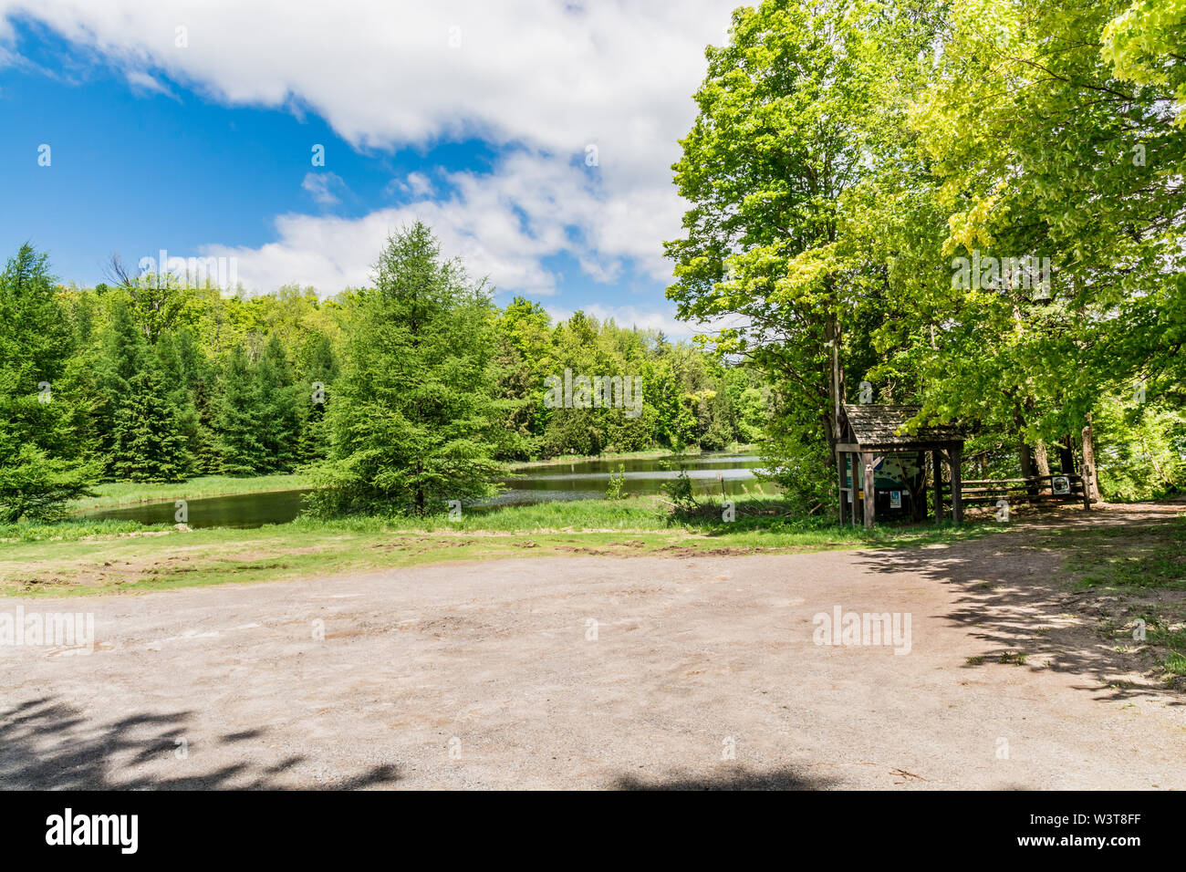 Conservation area with parking lot, trees and lake Stock Photo - Alamy
