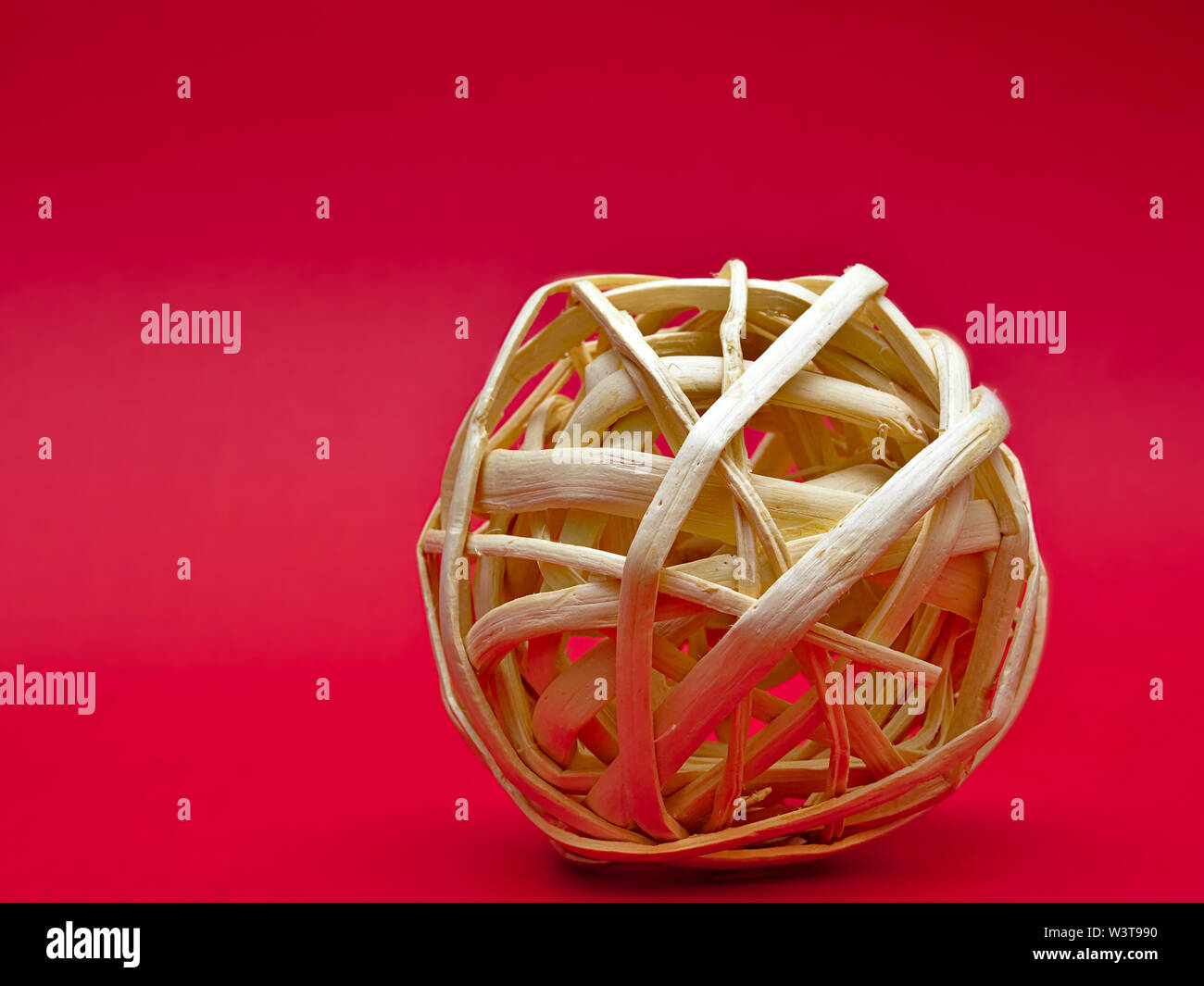 Decorative rattan ball isolated on red background with copy space Stock ...