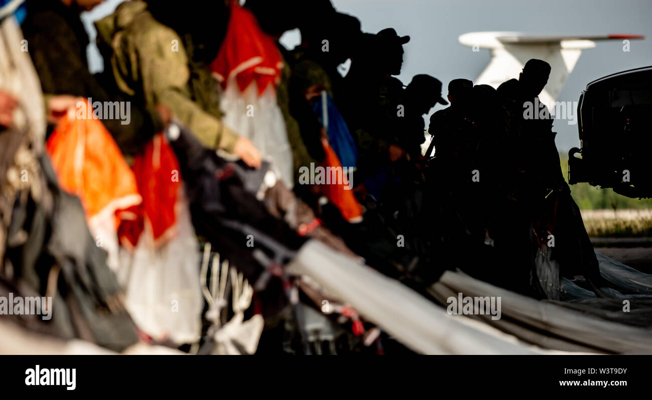 The hands of soldiers collect parachute lines. Preparing to jump. Army ...