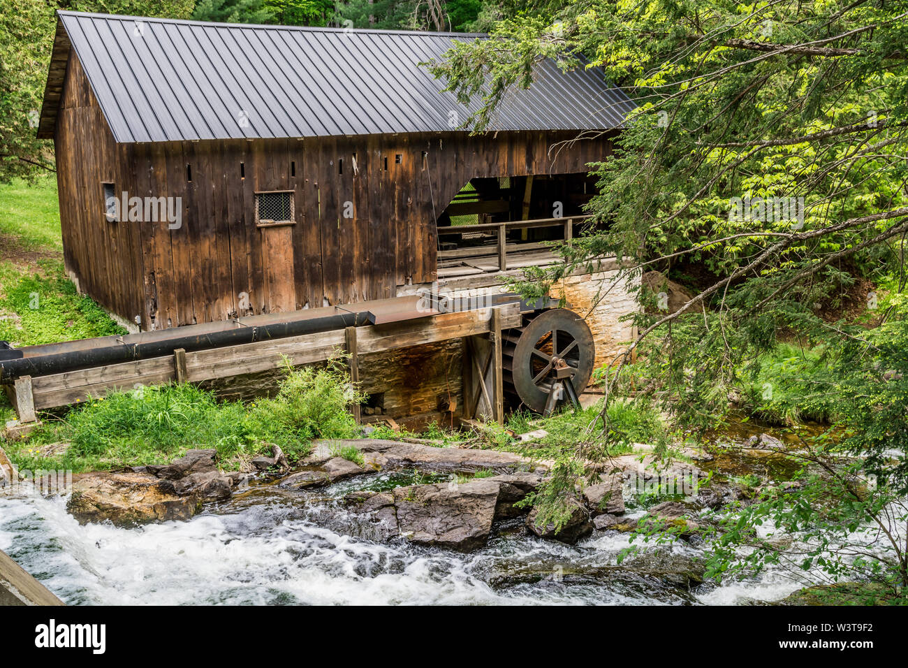 Old mill building showing water and mill wheel Stock Photo - Alamy
