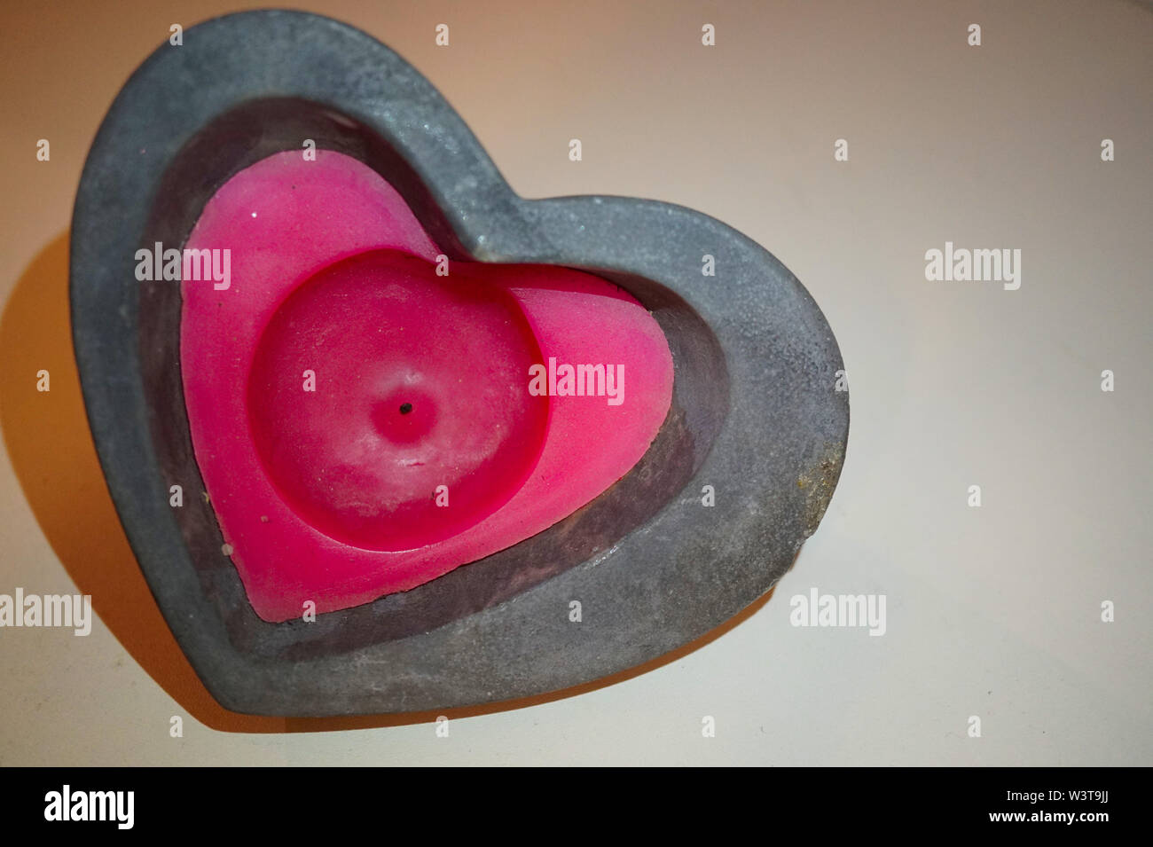 Red heart shaped candle. Heart shape red candle surrounded with black ...