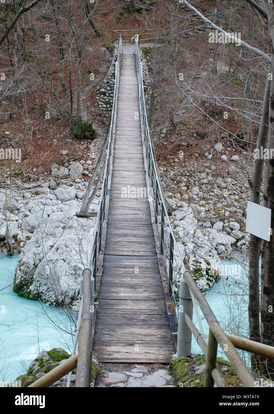 A wood and rope suspension bridge in Slovenia over the Soca River ...