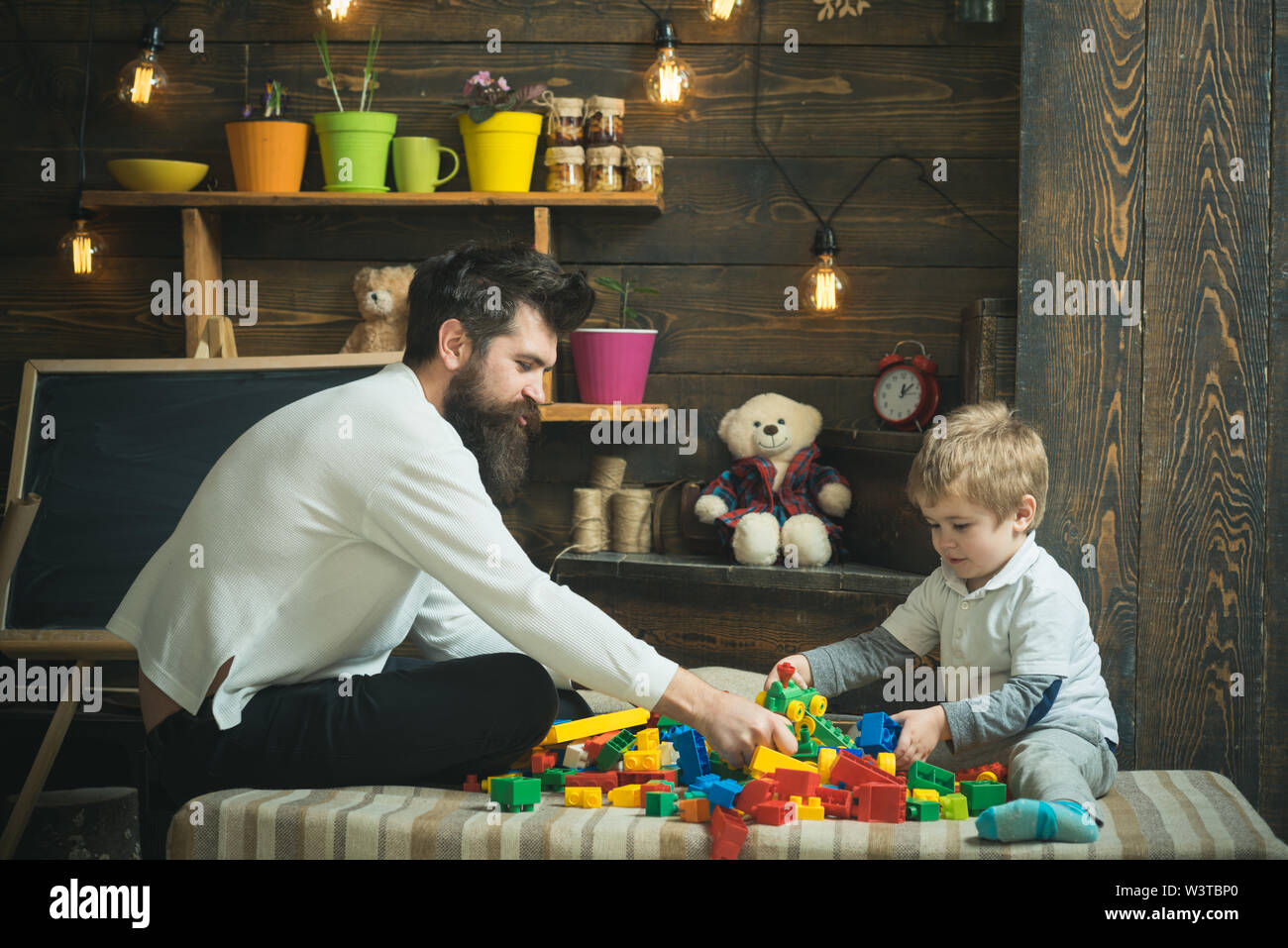 Family playing with constructor at home. Dad and child play with toy ...