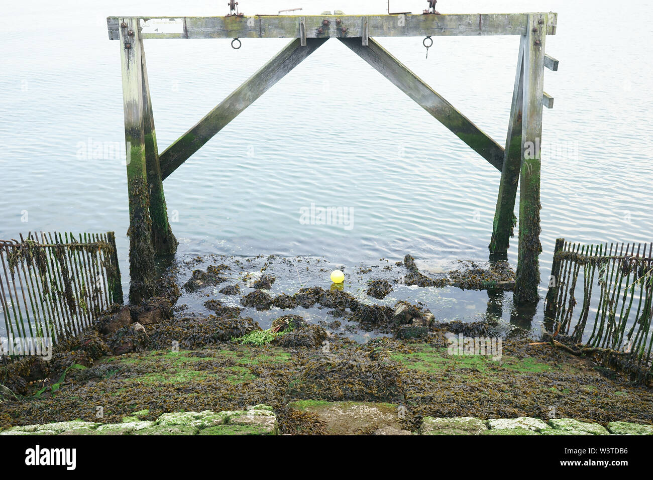 Wide boat ramp gently sloped down to clam and foggy sea Port of ...