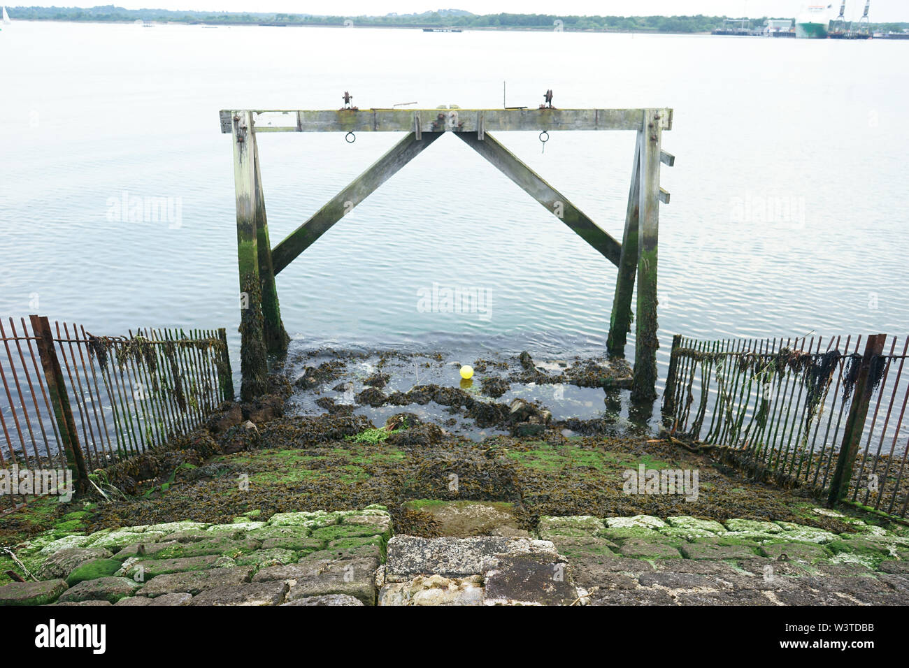 Wide boat ramp gently sloped down to clam and foggy sea Port of ...