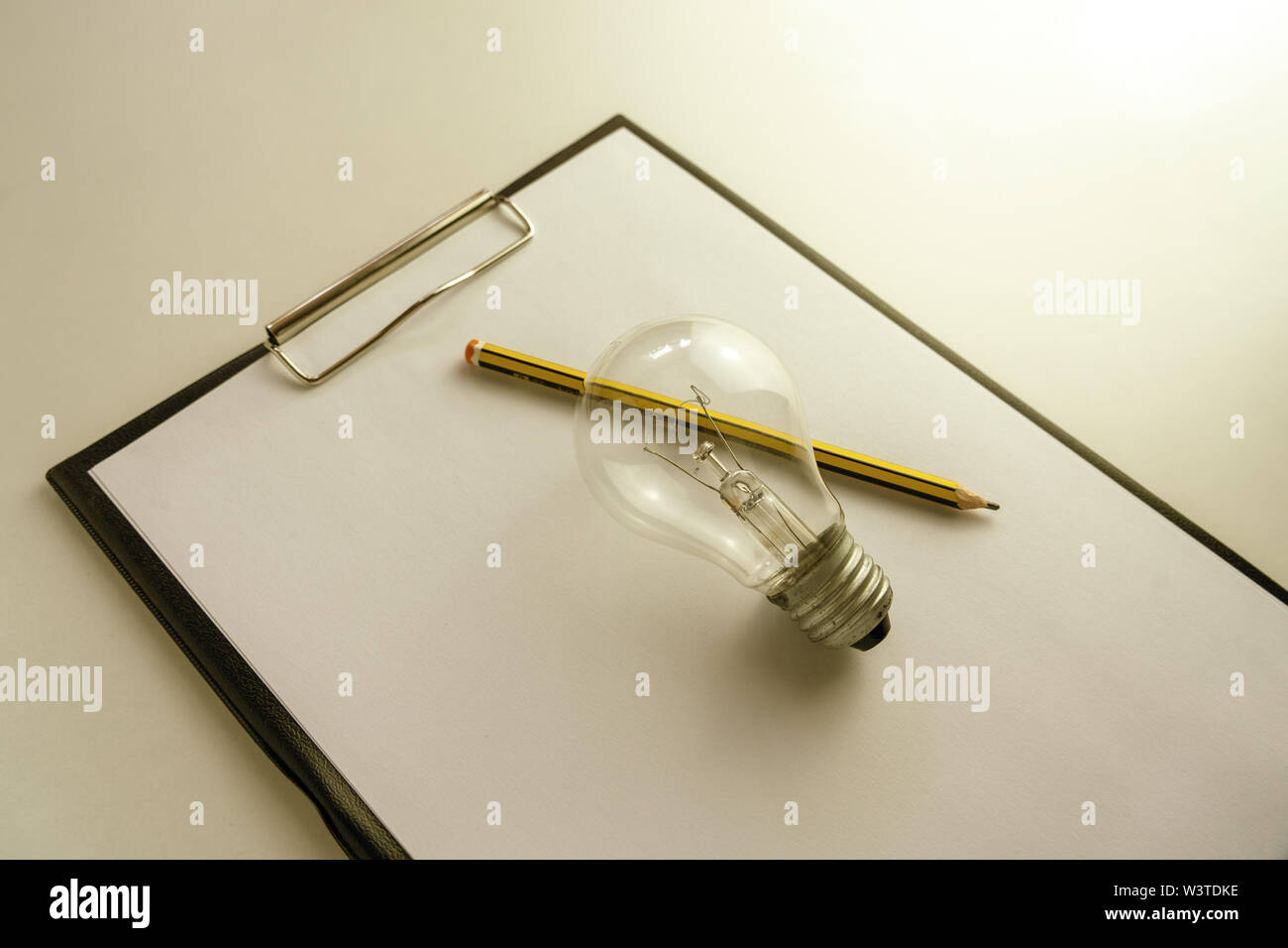 Blank paper with an light bulb and pencil waiting for idea concept ...