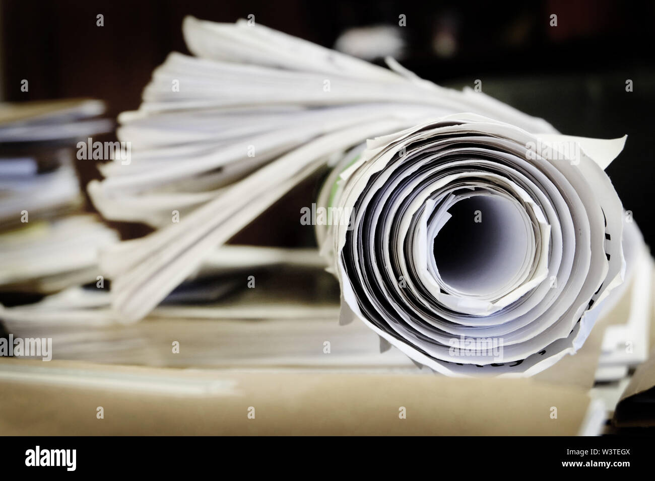 Roll of paper in office on desk drafts or blueprints Stock Photo - Alamy