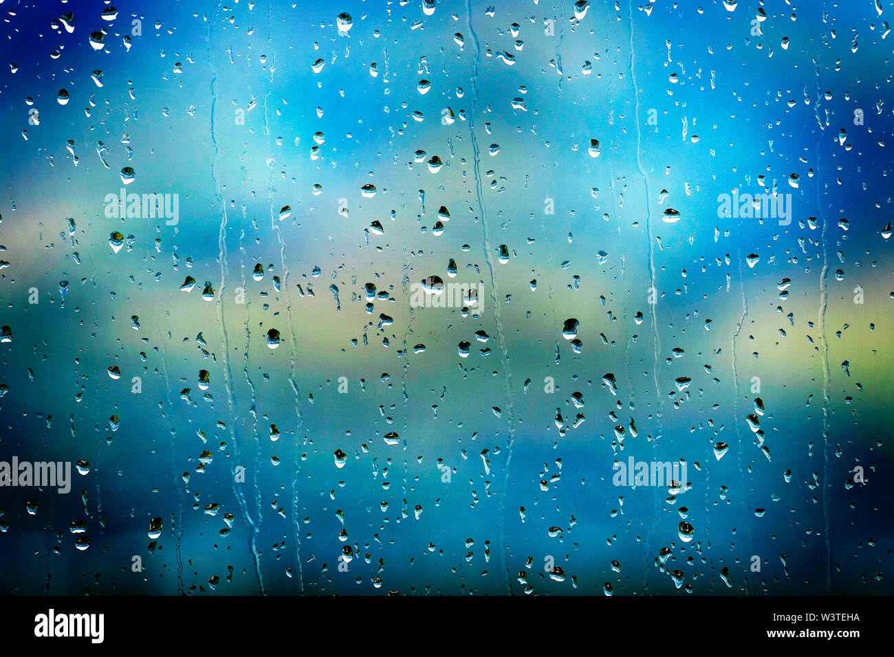 Rain drops drips water wet on window glass Stock Photo - Alamy