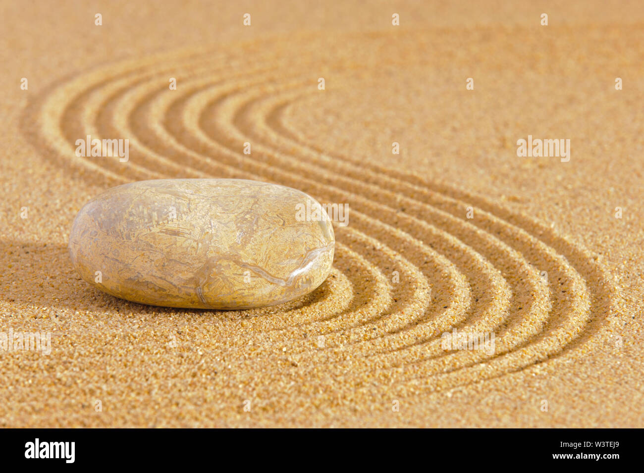 Japanese ZEN garden in sand with stone Stock Photo - Alamy
