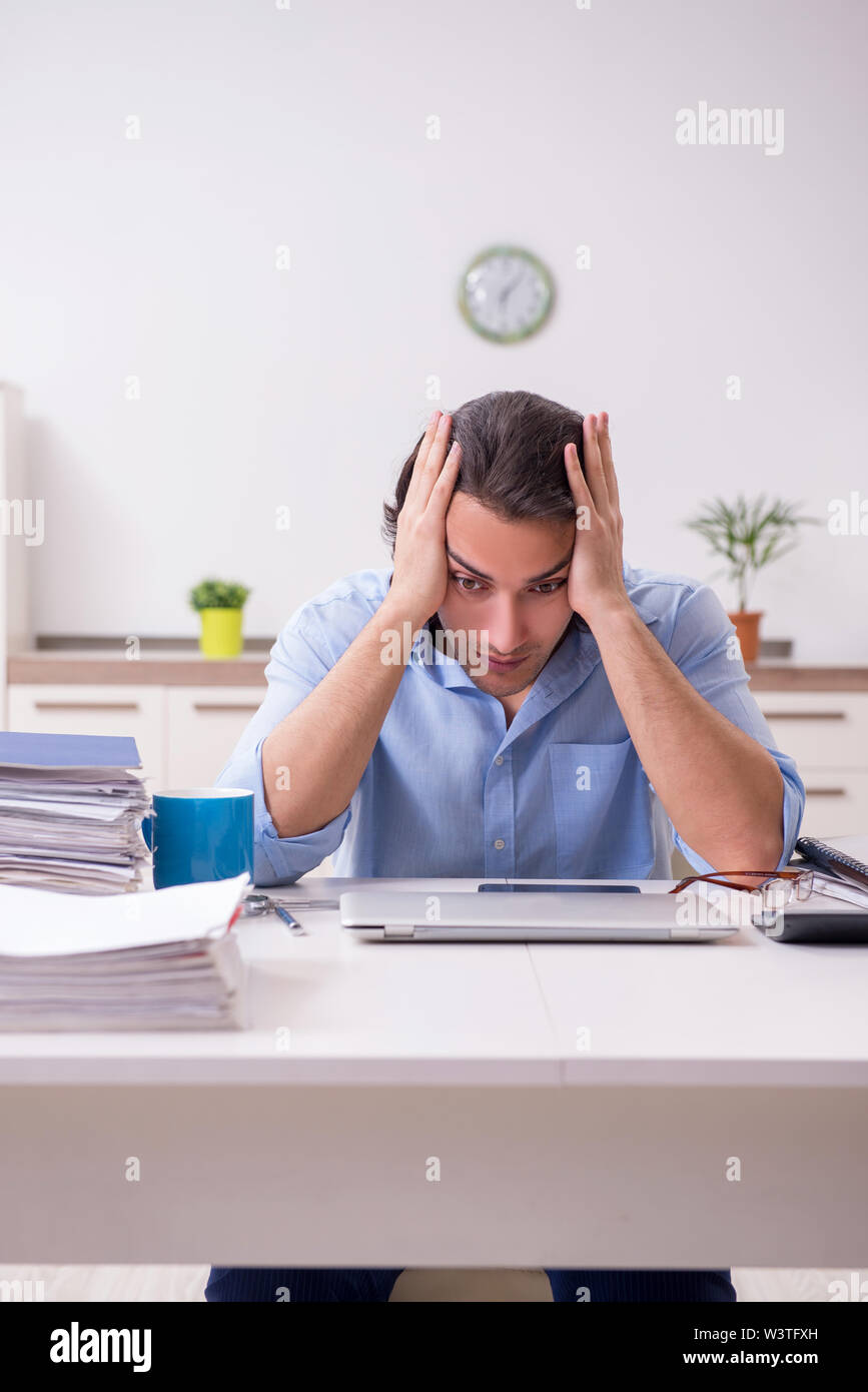 The young male employee working at home Stock Photo - Alamy