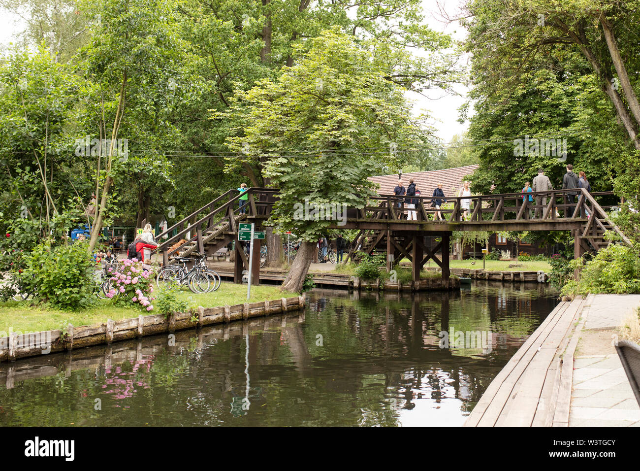 Tourists cross a footbridge over the canal in Lehde, a village in the ...