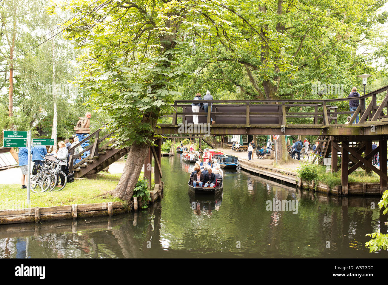 A tour boat passes under a footbridge in Lehde, a village in the ...