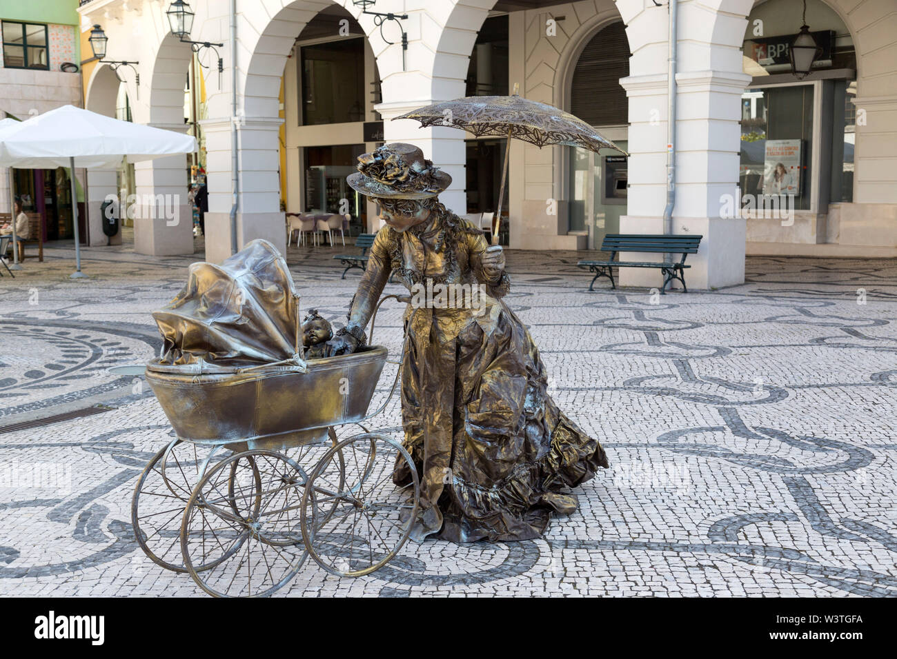 Female street performer, dressed as nanny with baby buggy on the ...