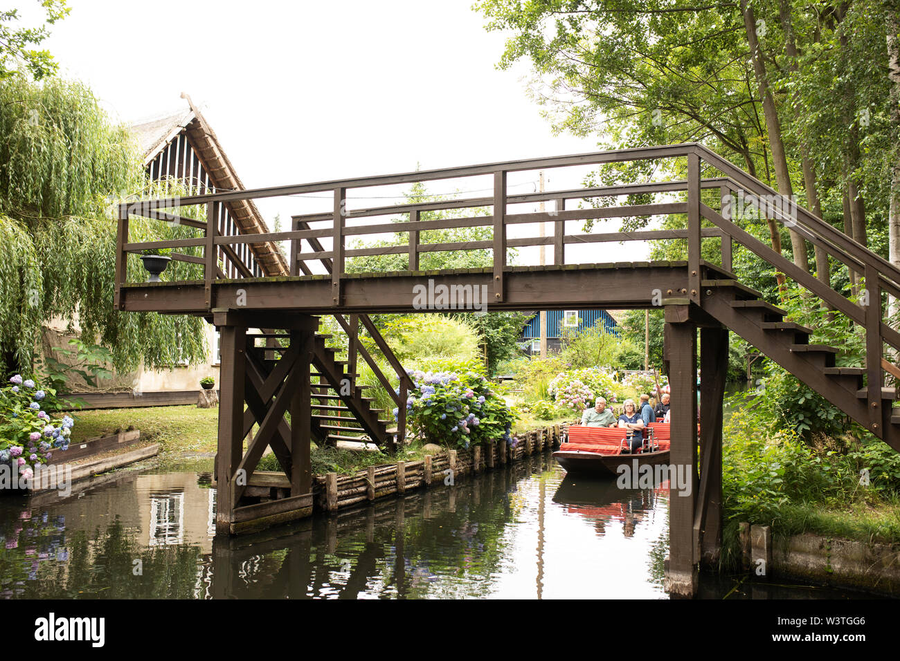 A tour boat passes under a footbridge in Lehde, a village in the ...