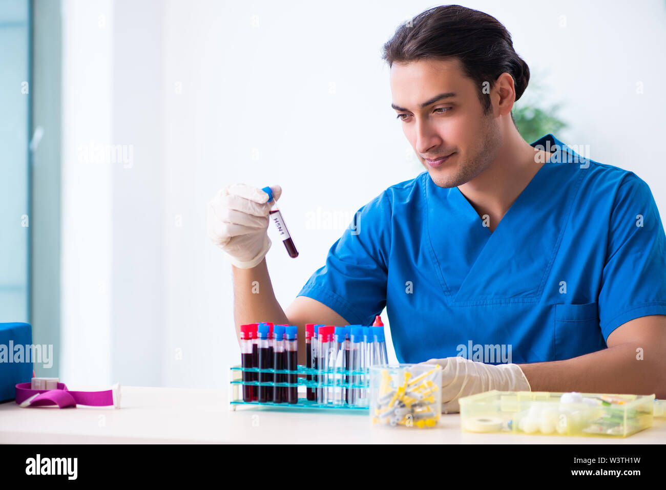 The young lab assistant testing blood samples in hospital Stock Photo ...