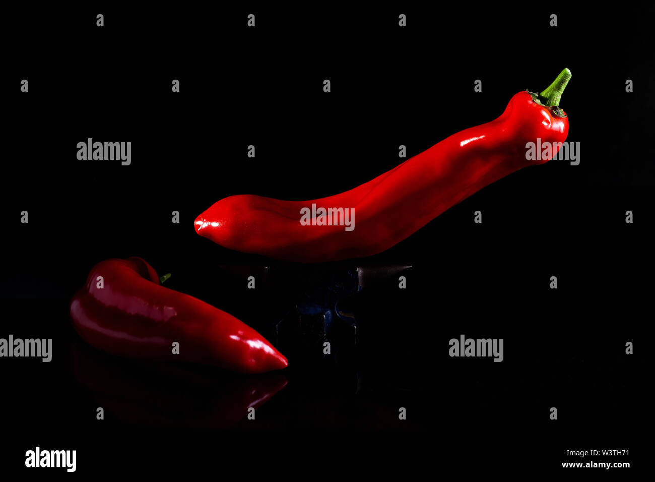 Two red chilli peppers on top of a black analogue camera Stock Photo ...