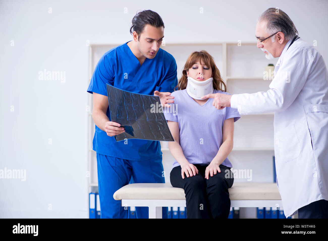 The two doctors examining young woman Stock Photo - Alamy