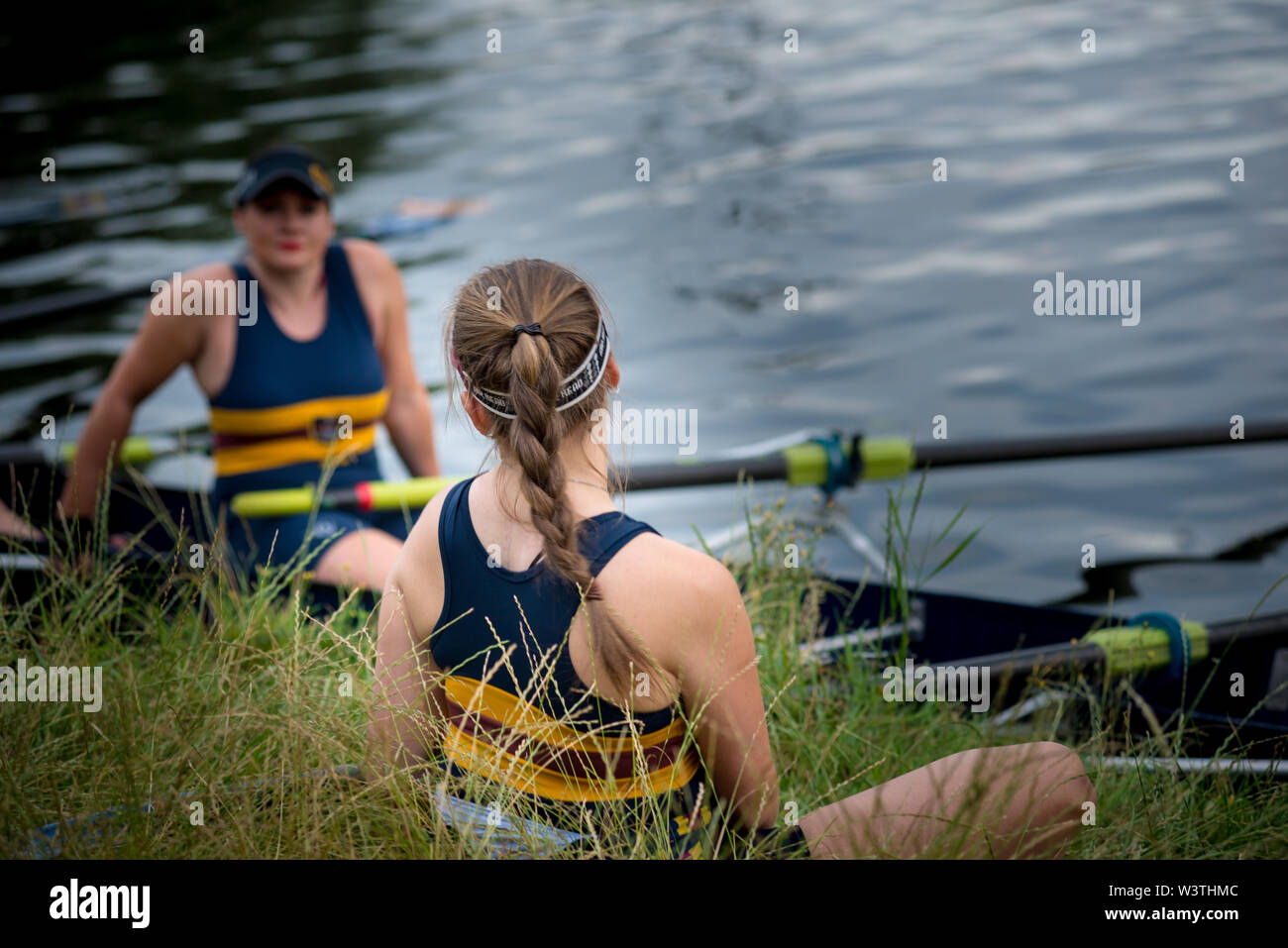 Cambridge UK, 2019-07-17. Two female rowers resting before taking part ...