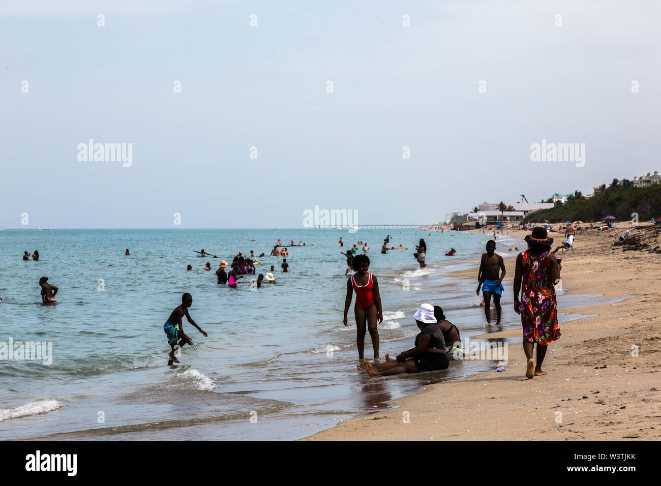 Tourists play in the warm waters off Carlin Park in Jupiter, Florida ...