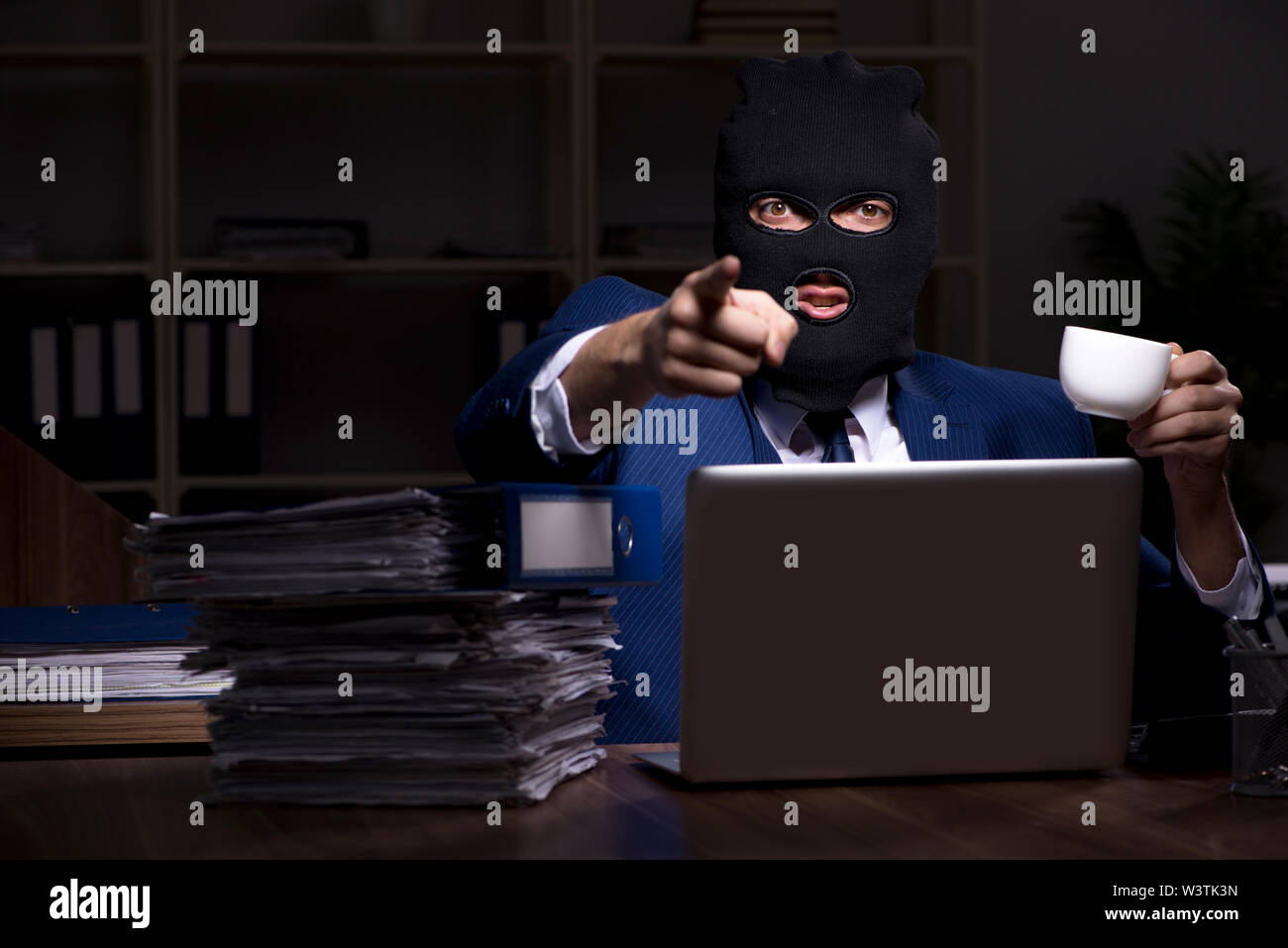 The male employee stealing information in the office night time Stock ...
