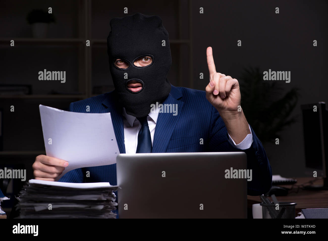 The male employee stealing information in the office night time Stock ...