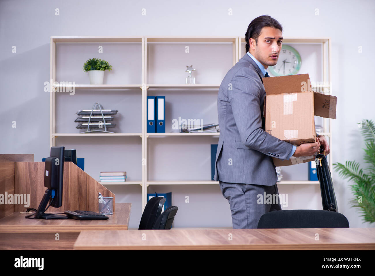 The young male employee being fired from his work Stock Photo - Alamy