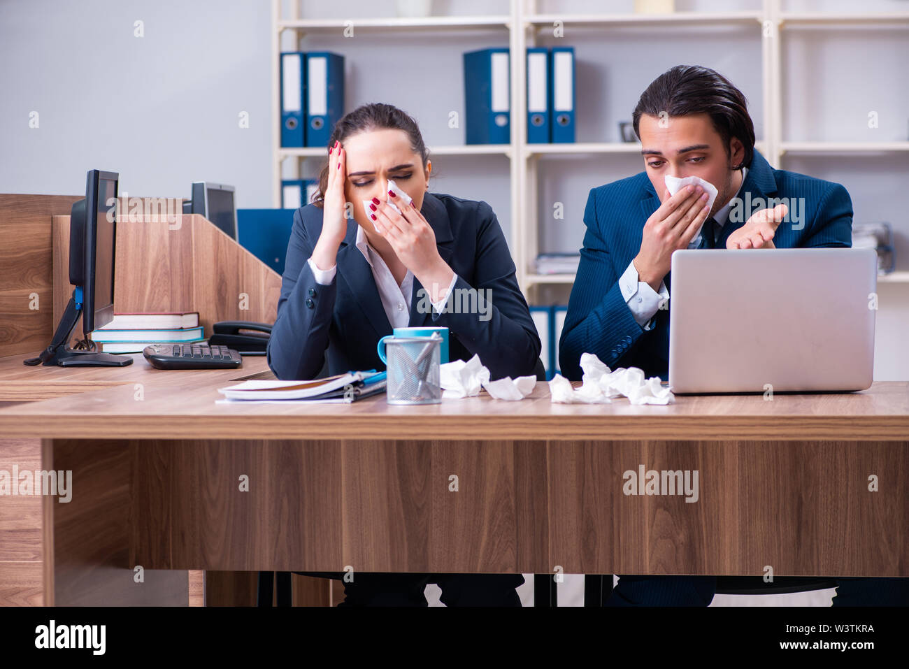 The two employees suffering at workplace Stock Photo - Alamy