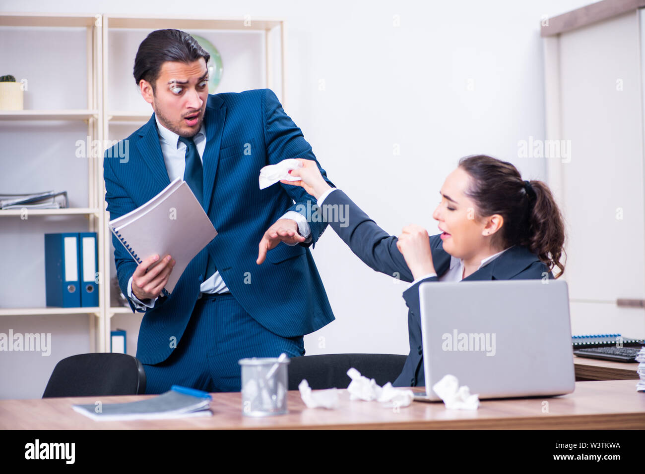 The two employees suffering at workplace Stock Photo - Alamy