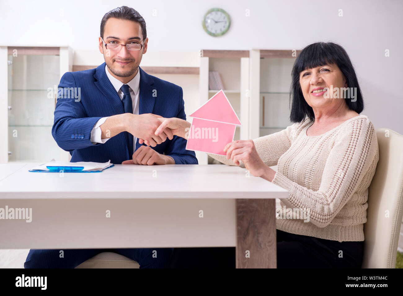 The male real estate agent and female client in the apartment Stock ...