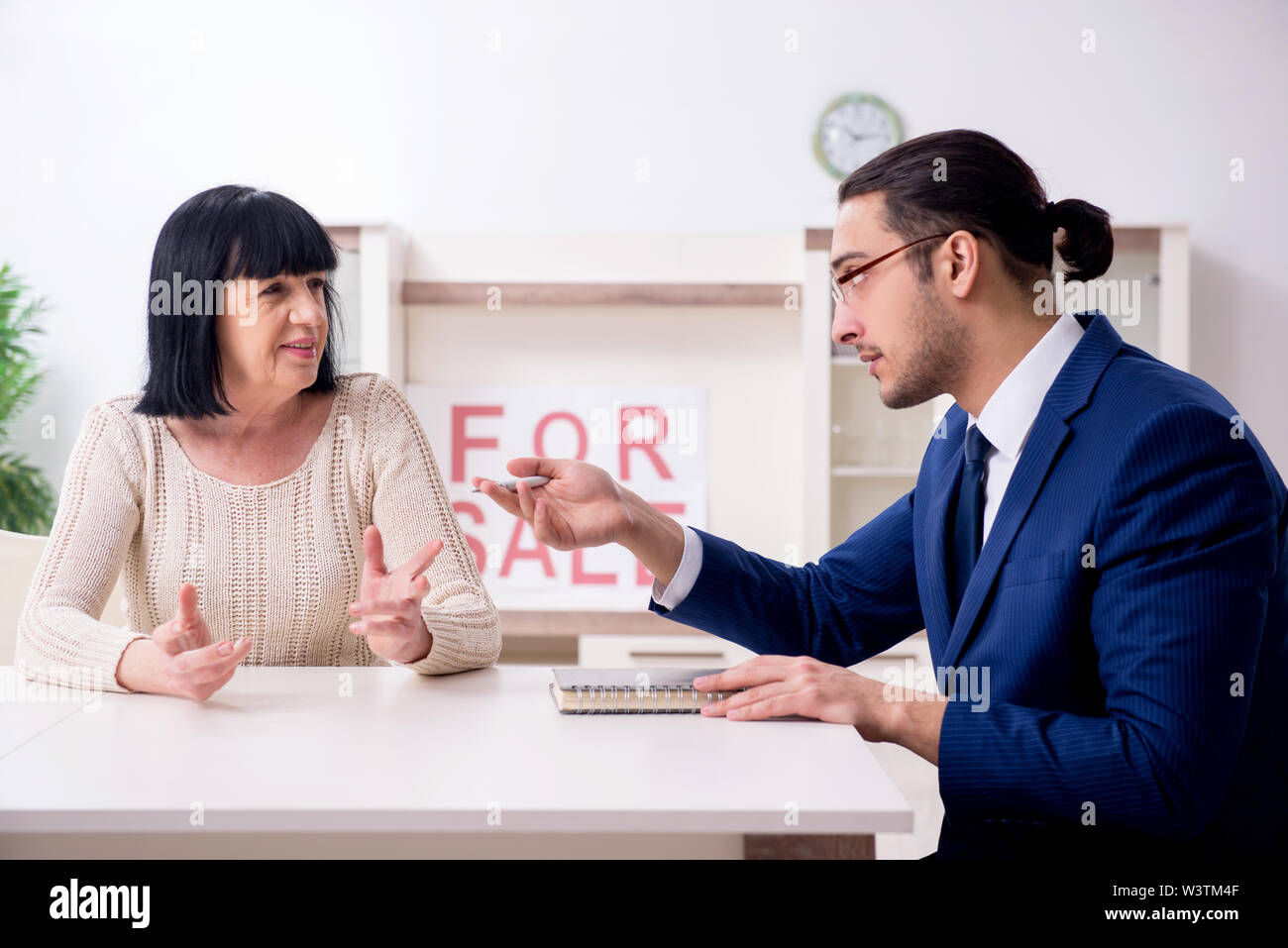 The male real estate agent and female client in the apartment Stock ...
