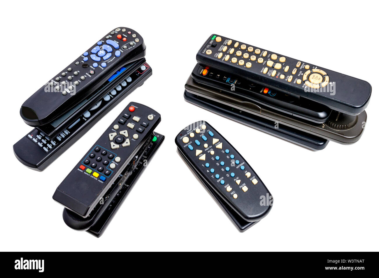 Horizontal shot of four stacks of old remote controls. White background ...