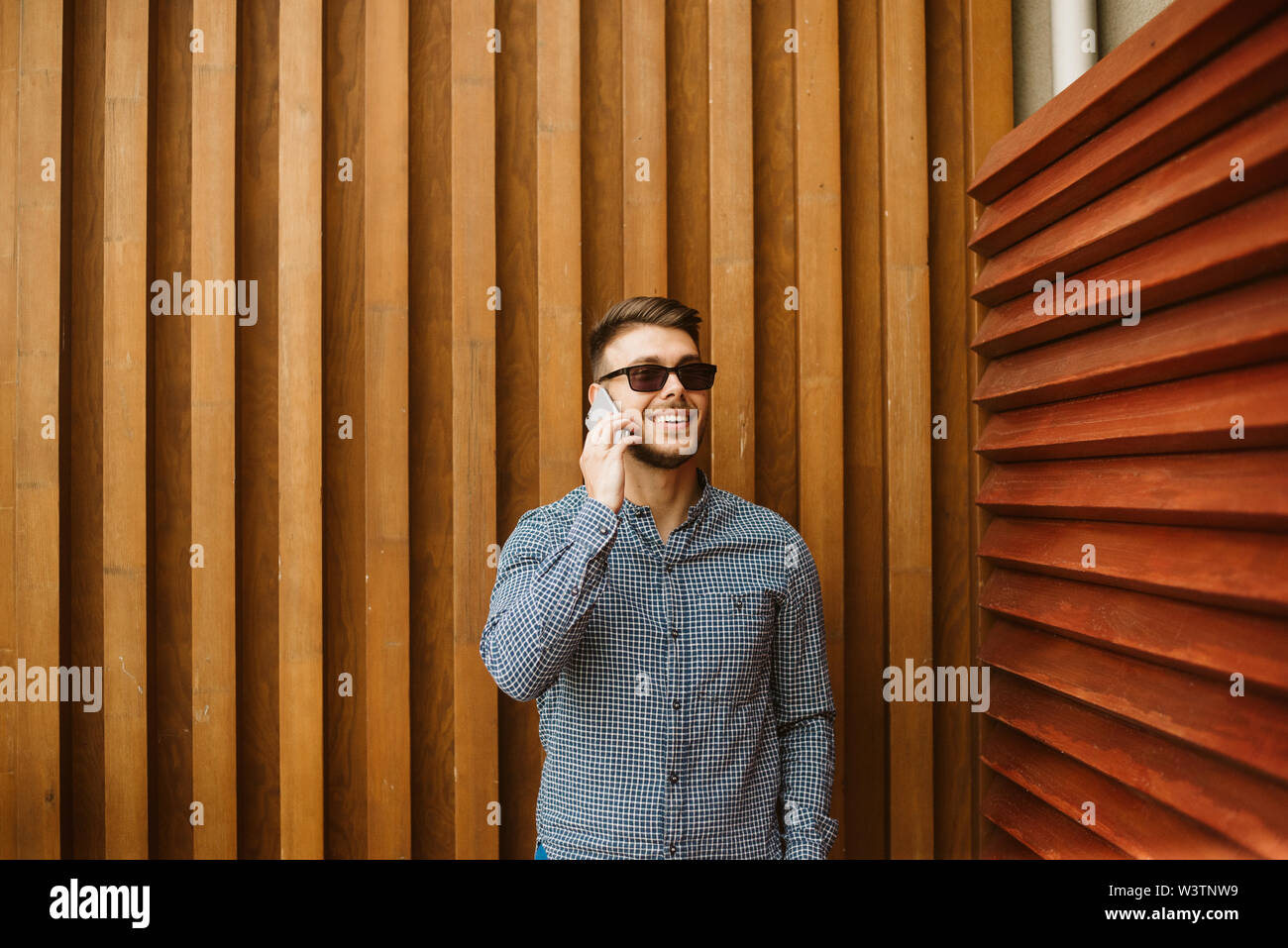 Man using mobile phone while walking on street to office Stock Photo ...