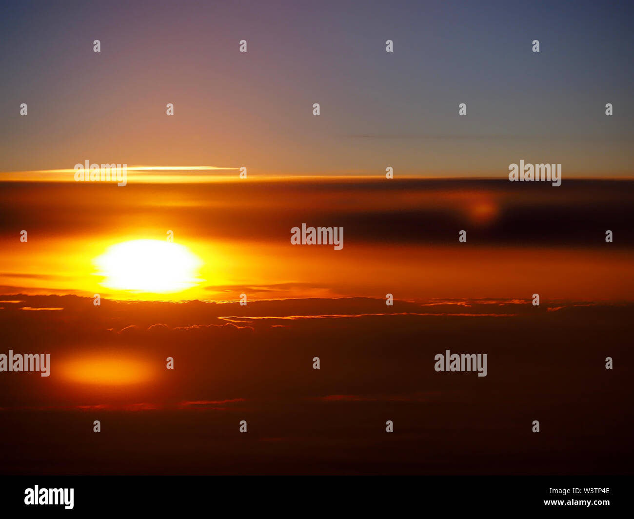Sunset in a cloud seen on a flight with an airplane Stock Photo - Alamy