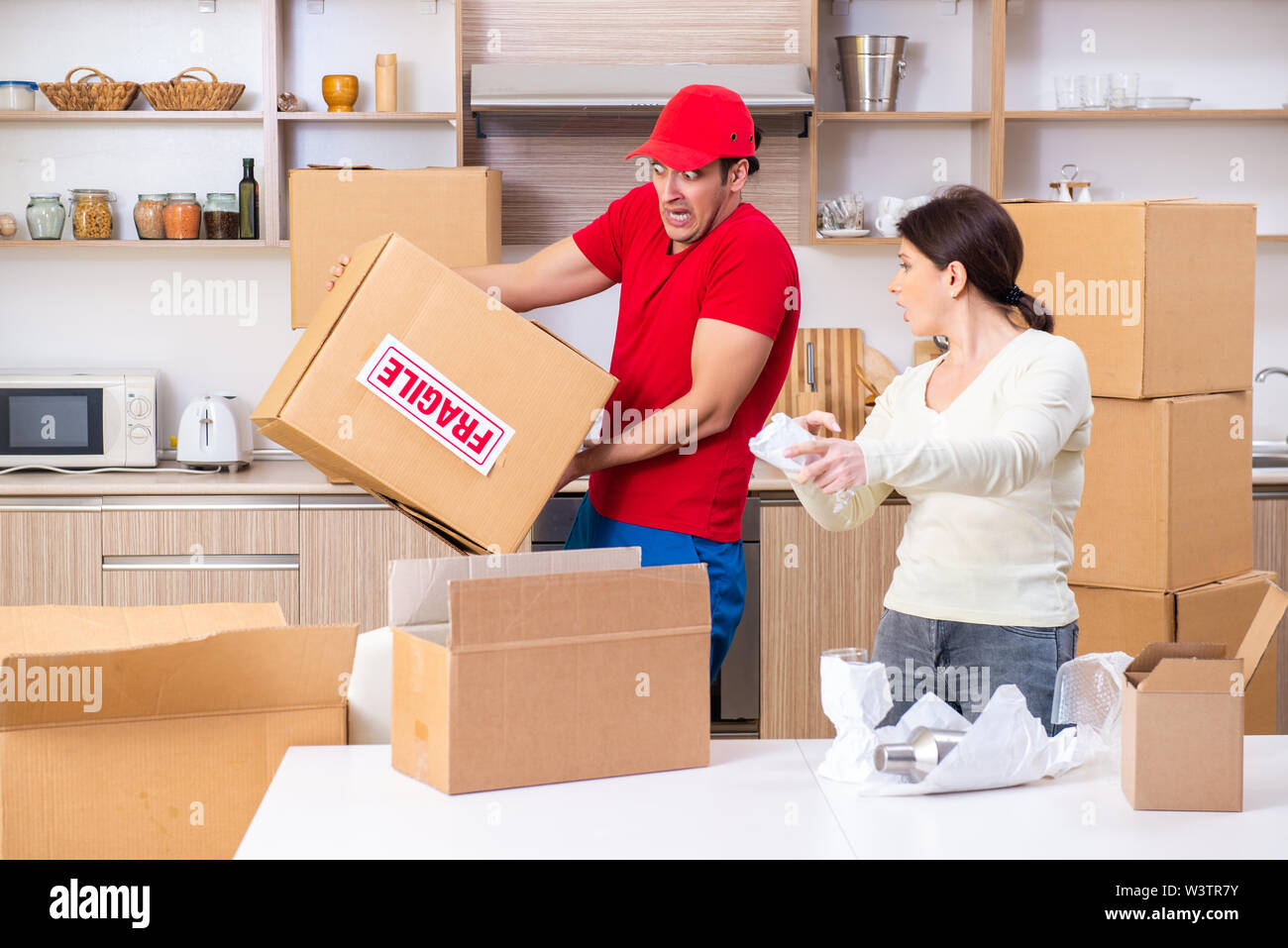 The young male contractor and female customer in moving concept Stock ...