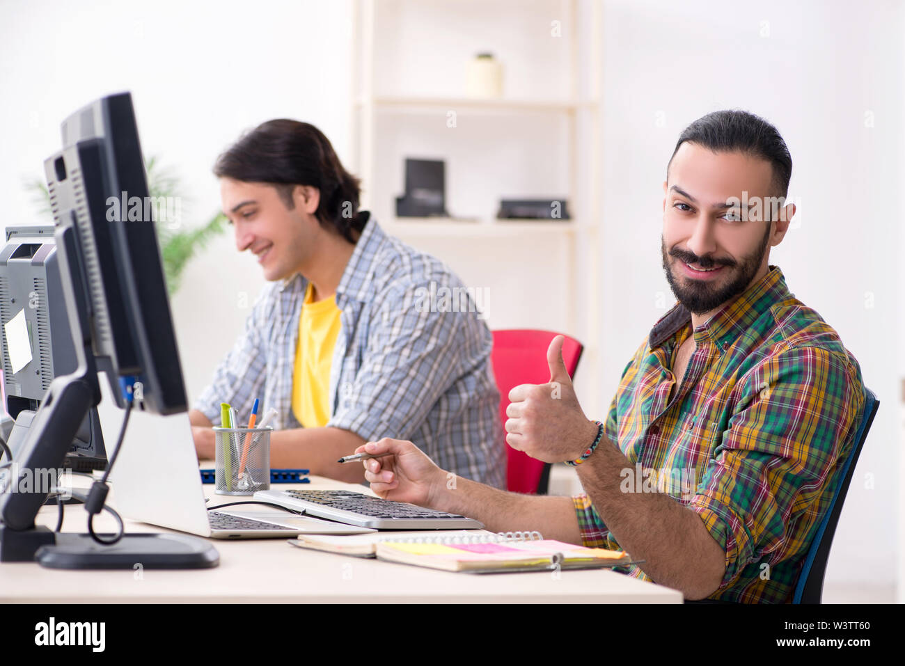 The two it specialists working in the office Stock Photo - Alamy