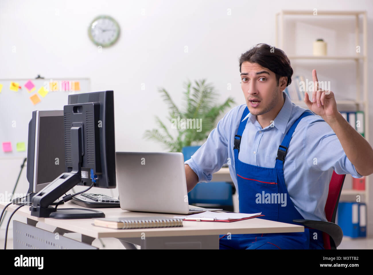 The male it specialist working in the office Stock Photo - Alamy