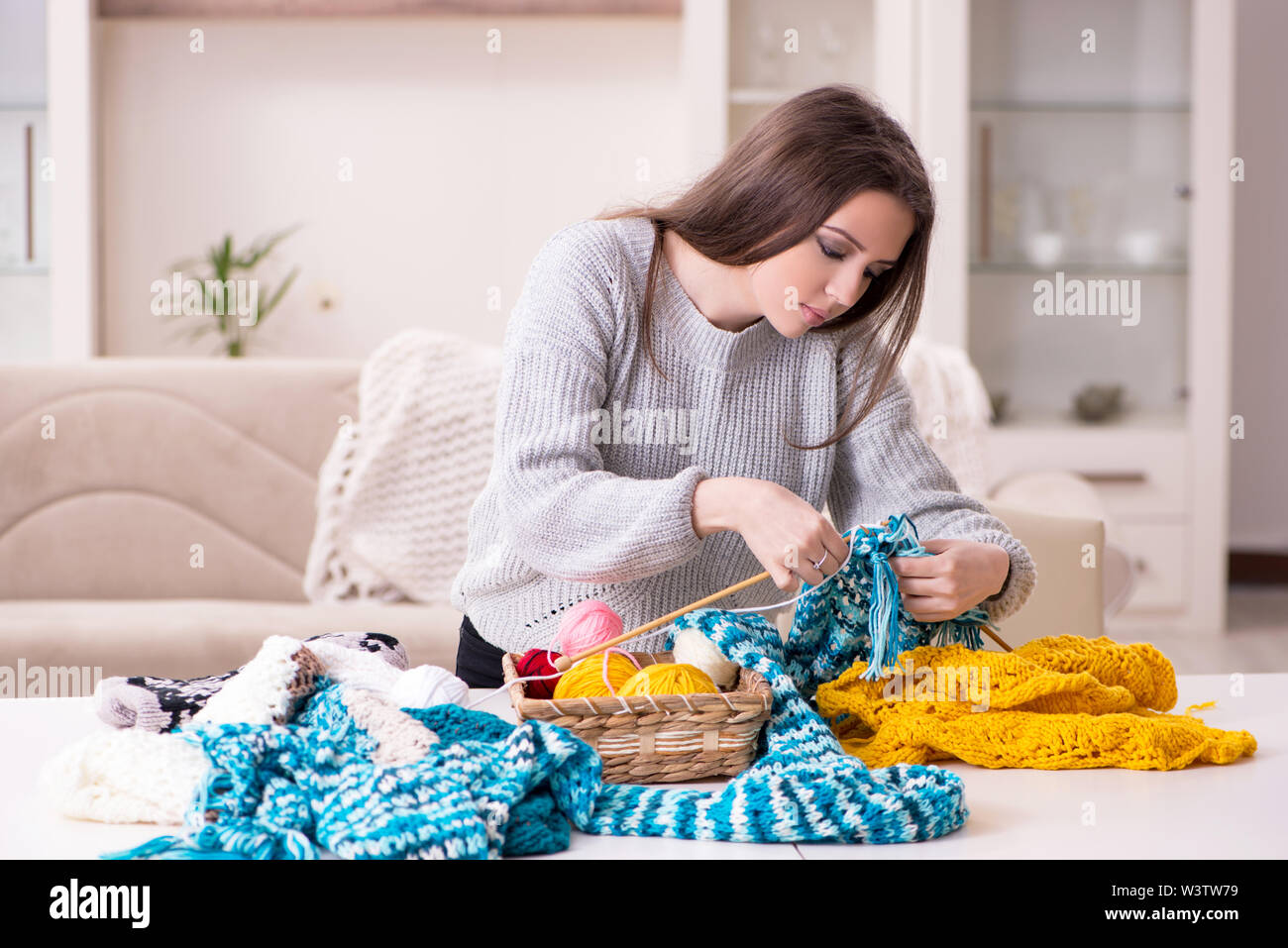 The young beautiful woman knitting at home Stock Photo - Alamy