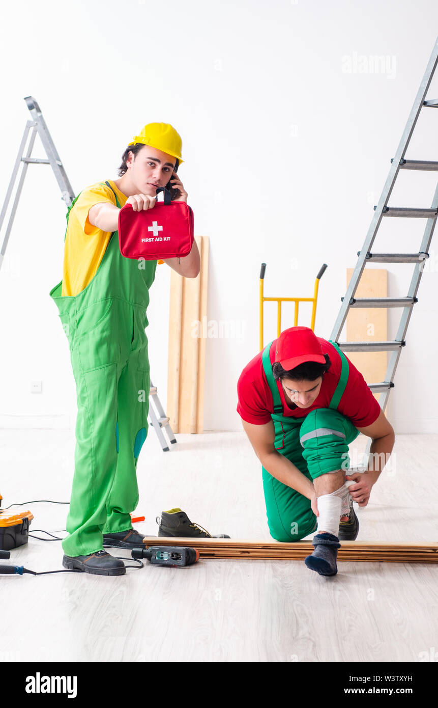 The injured worker and his workmate Stock Photo - Alamy