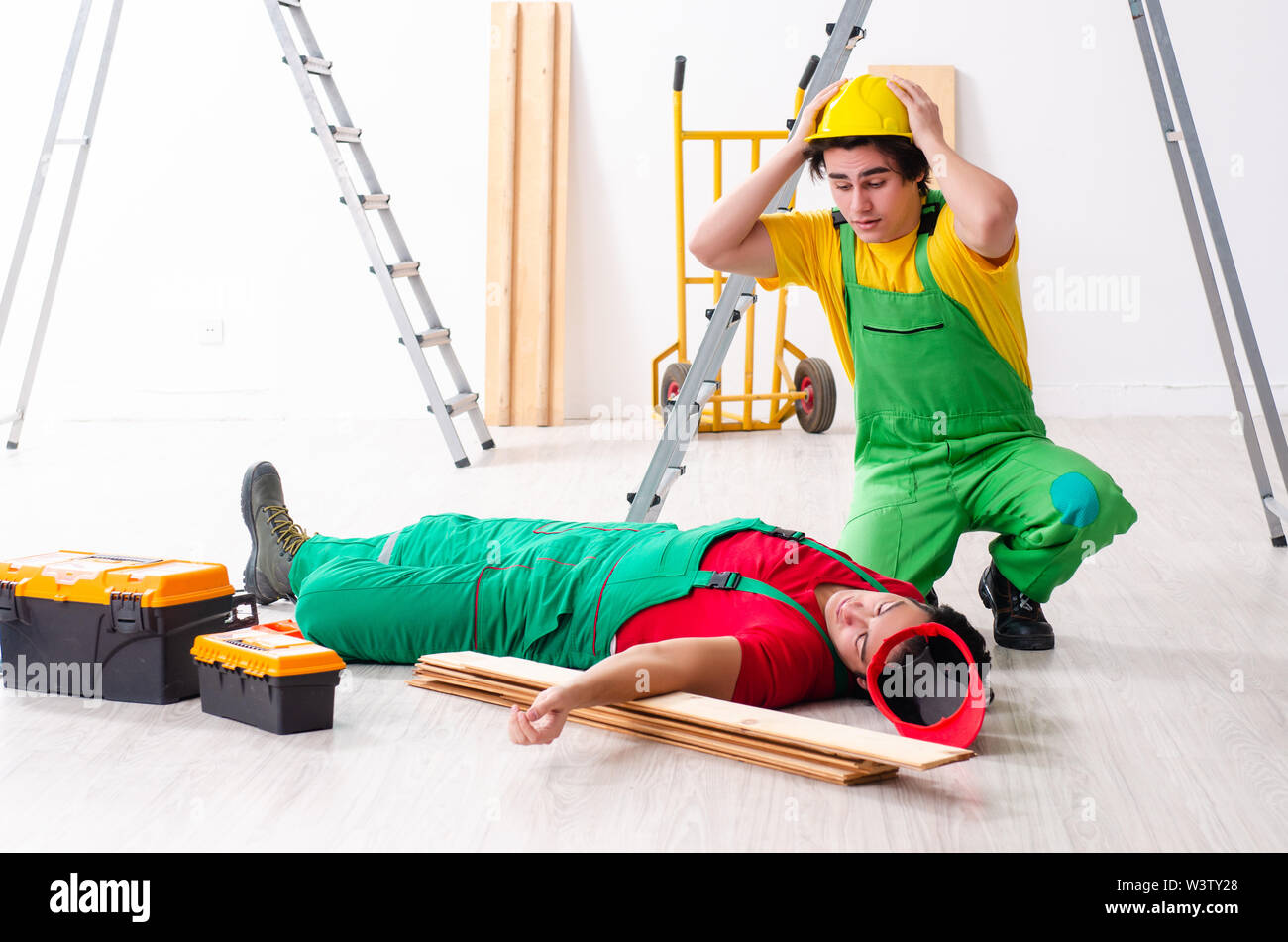 The injured worker and his workmate Stock Photo - Alamy