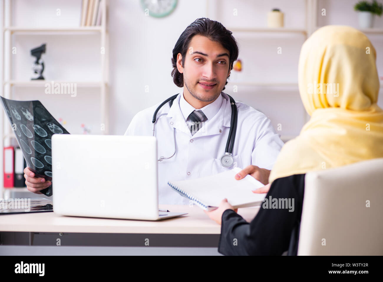 Thefemale arab patient visiting male doctor Stock Photo - Alamy