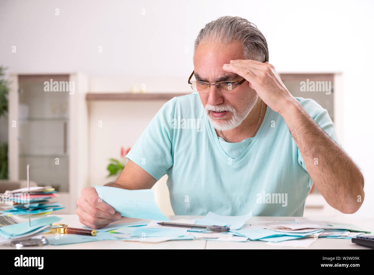 The white bearded old man in budget planning concept Stock Photo - Alamy