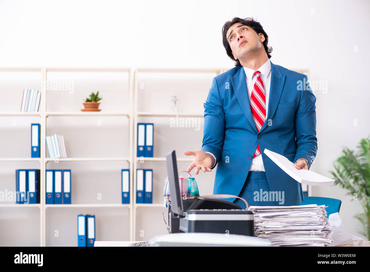 The young employee making copies at copying machine Stock Photo - Alamy